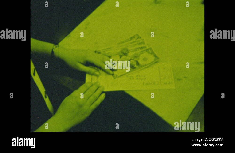 1970s: Patrons in bank. Transactions. Adding machine. Bills and coins ...