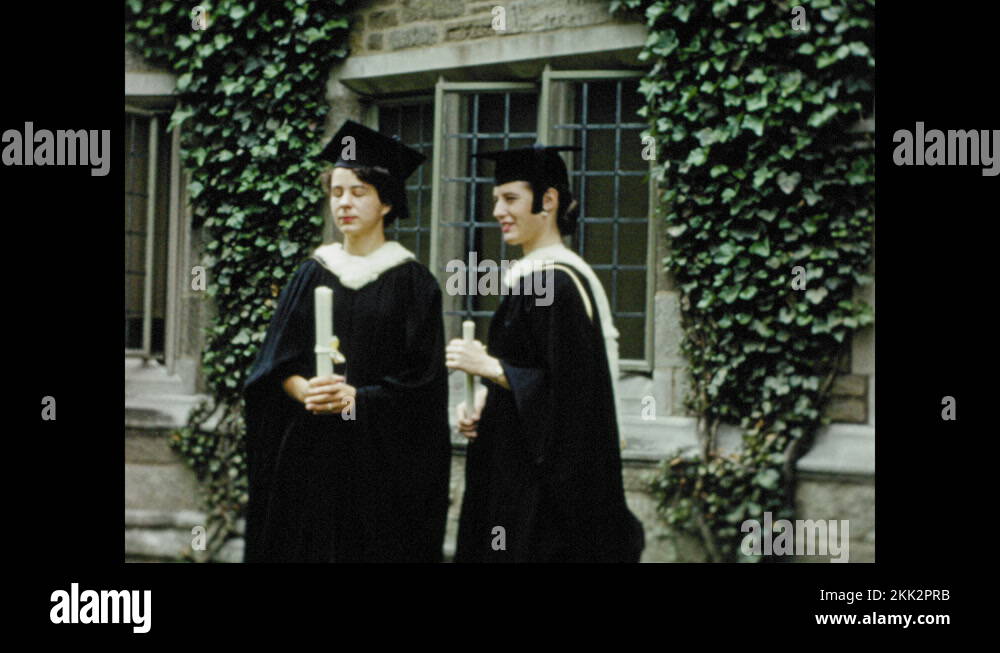 1950s: Two graduates in cap and gown pose with diplomas at Bryn Mawr ...