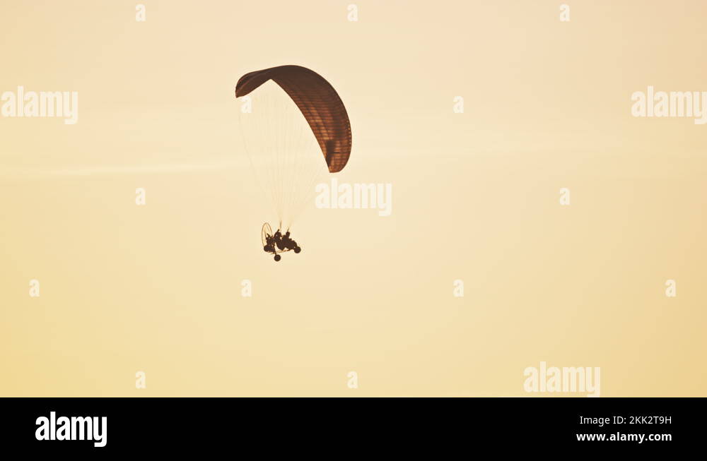 Tandem Paramotor Gliding - two men flying and gliding in the air Stock ...