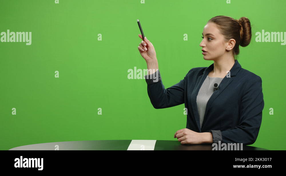 Female news anchor looking at camera and talking during broadcast ...
