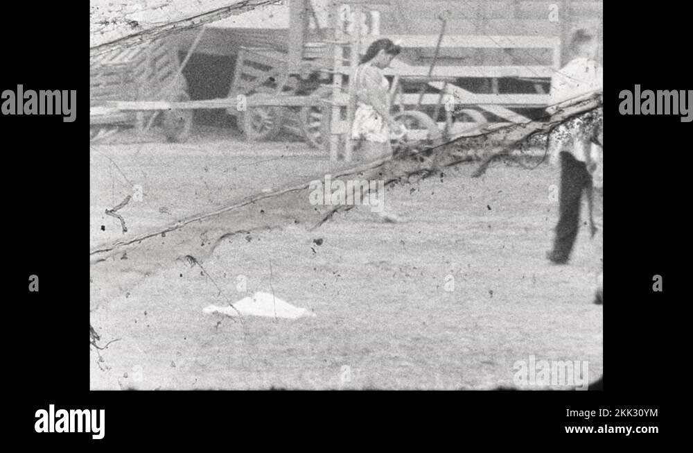 1940s: Various circus workers and performers pass by wagons; man ...