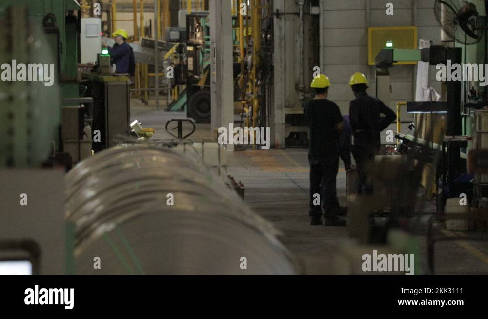Aluminum processing plant working with several operators and a forklift ...