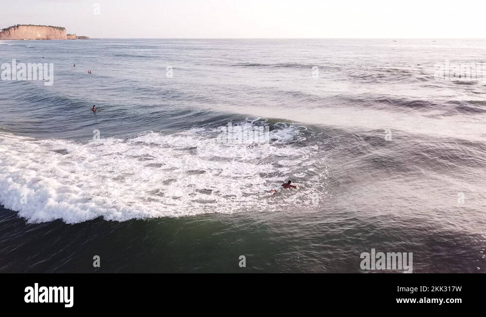 Emerald Ocean Water Surface With Surfers Floating At Olon Beach In ...