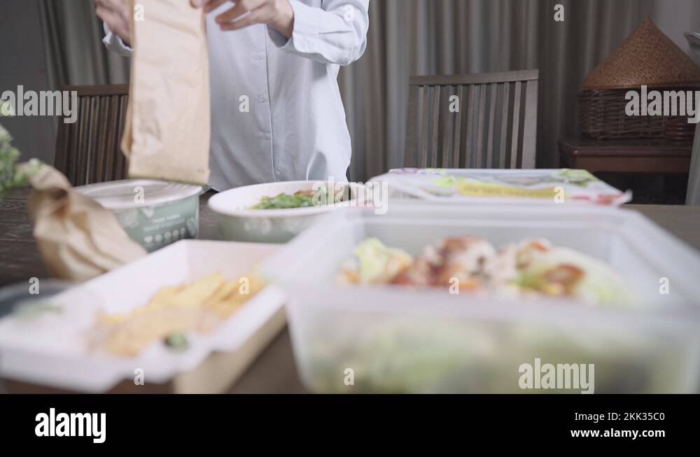 woman setting up food table, take home food, delivery service, take ...