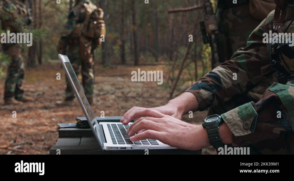 A bearded commander in a military uniform, in a tactical vest with a ...