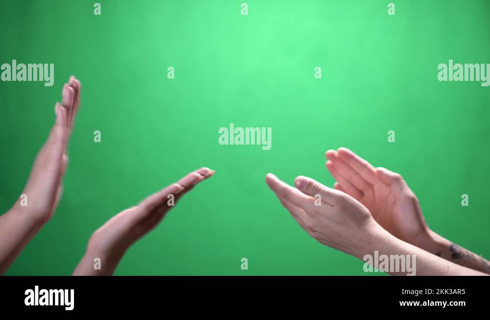 Hands are clapping on green screen background. Female and male hands ...