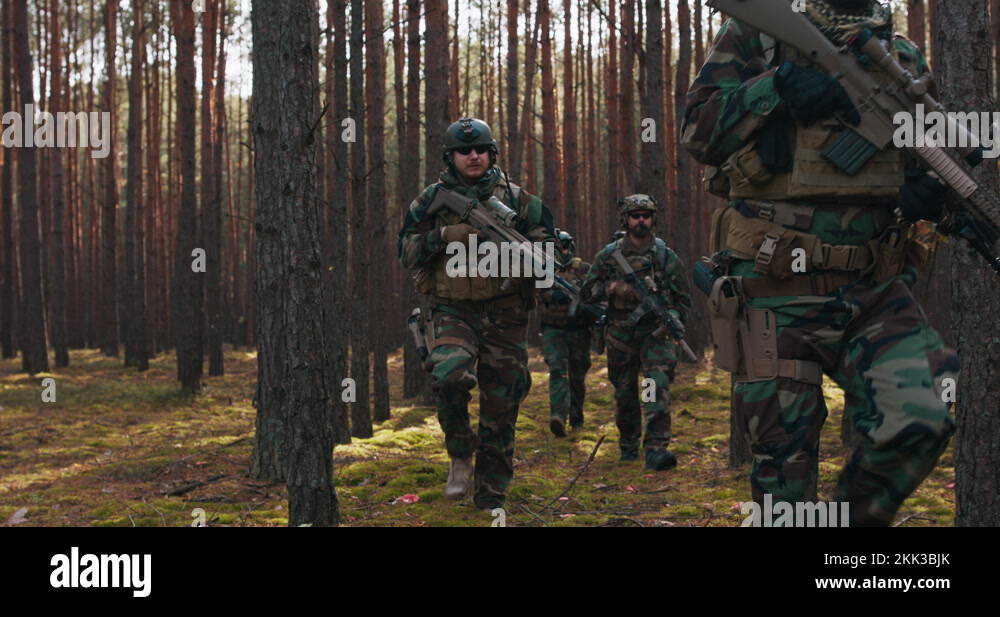 Squad of Four Fully Equipped Soldiers in Camouflage on a Reconnaissance ...