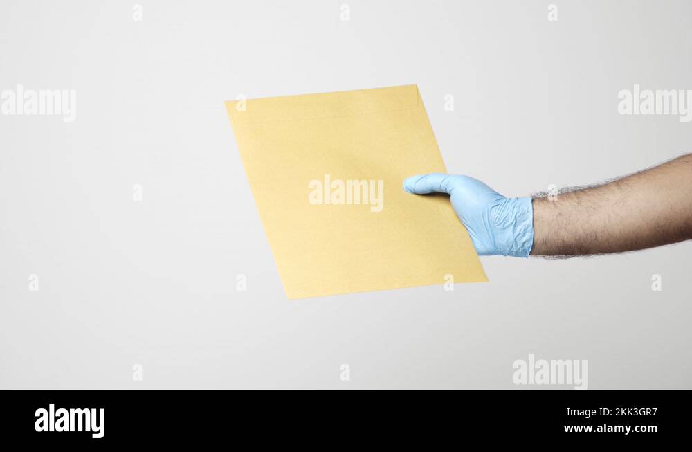 Close up hands postman wearing medical rubber gloves sending the mail ...