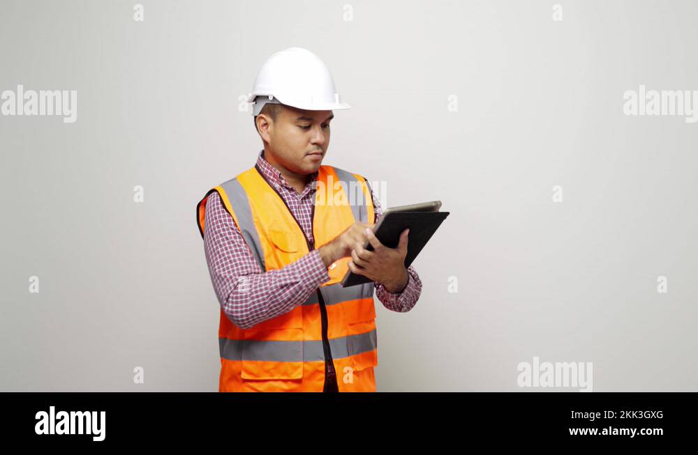 Asian civil engineer operate with tablet to control working at studio ...
