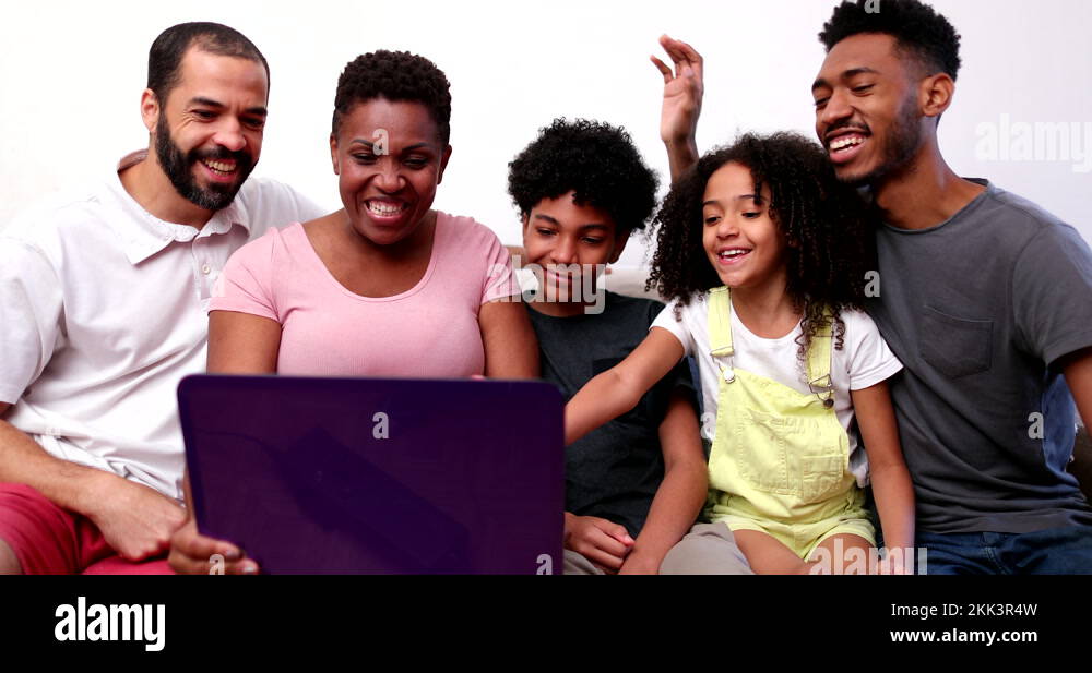 Family waving hands together HELLO or GOODBYE on laptop computer Stock ...