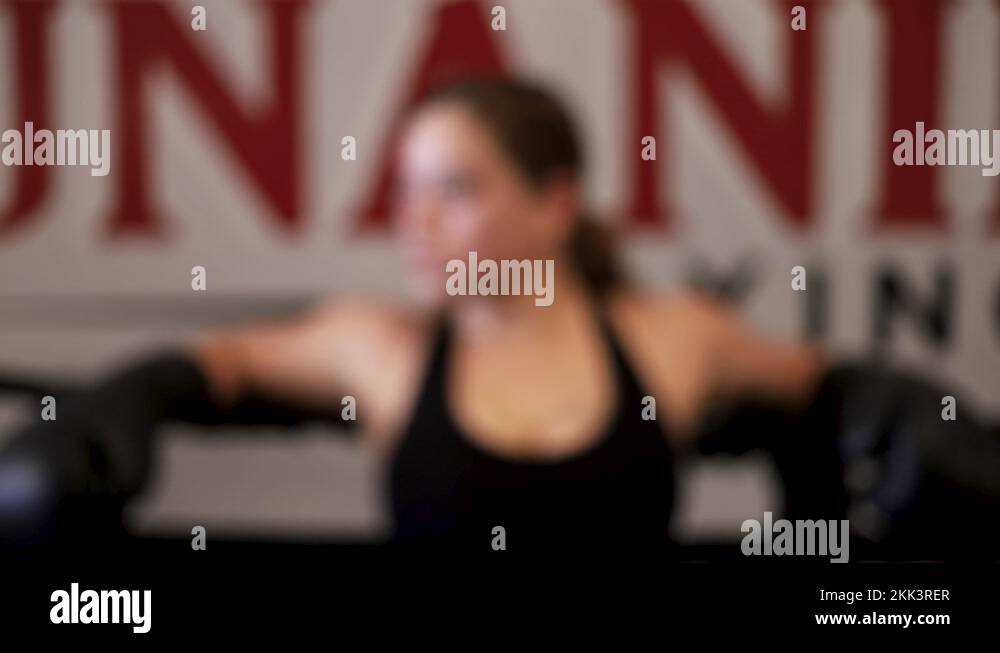 female boxer leaning against the rope of a boxing ring gym Stock Video ...
