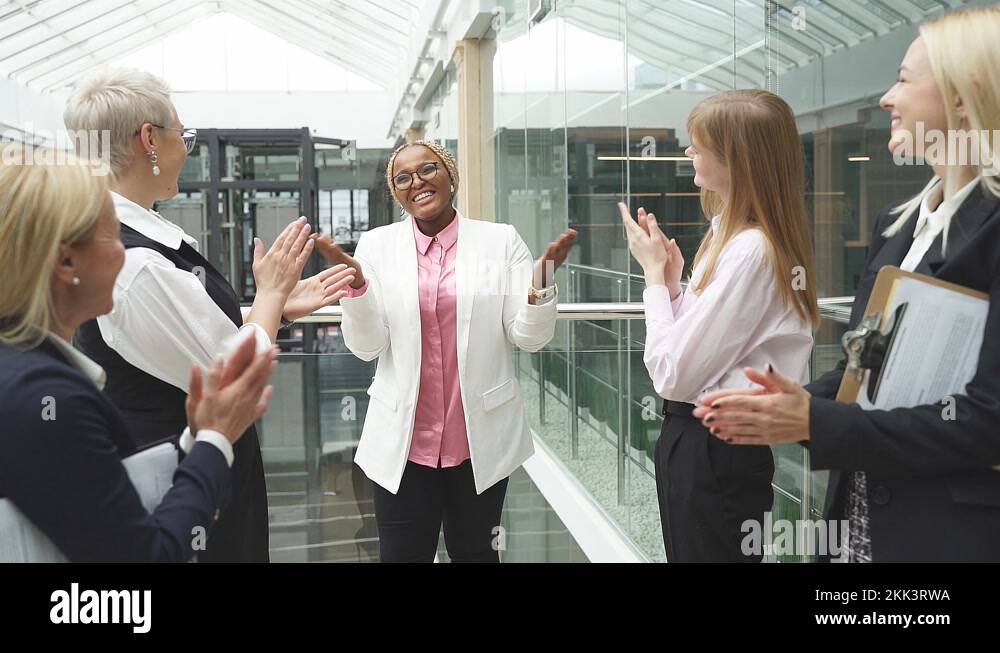 Afro american woman get congratulations by caucasian colleagues ...