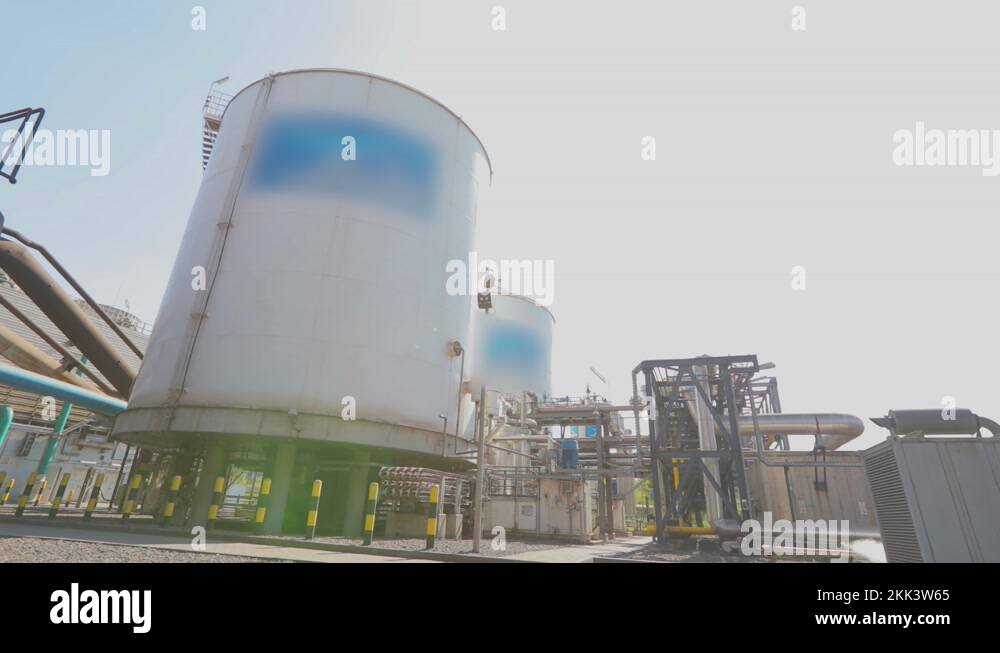 White storage tanks for liquids in a modern factory. Large storage ...