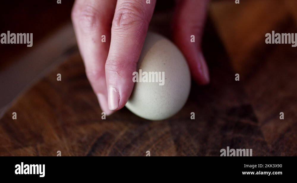 Cracking an egg and dropping the yolk into a recipe Stock Video Footage ...