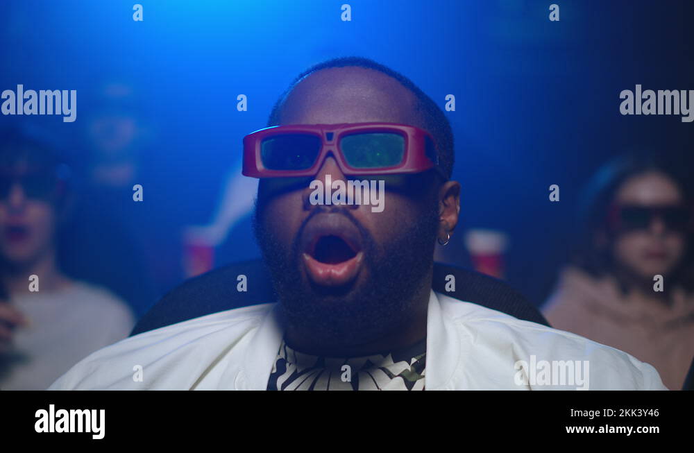 Afro man feeling shocked in movie house. African guy eating popcorn at 3d cinema Stock Video ...