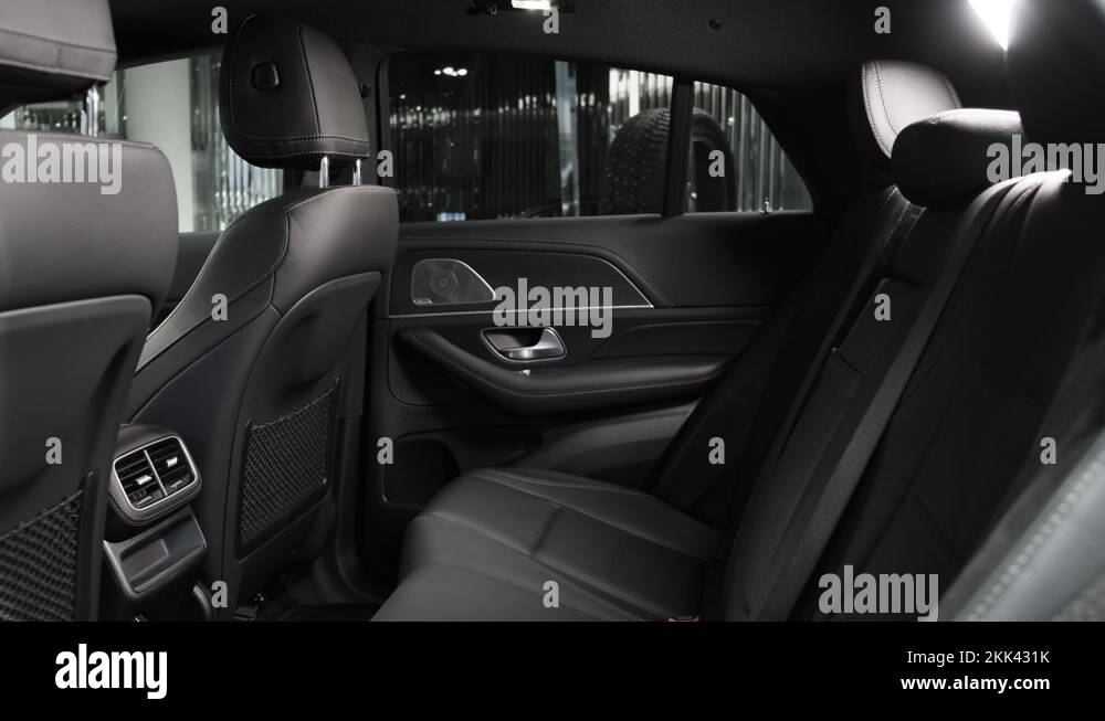 Rear seats of passengers of the new premium SUV. Black leather interior ...