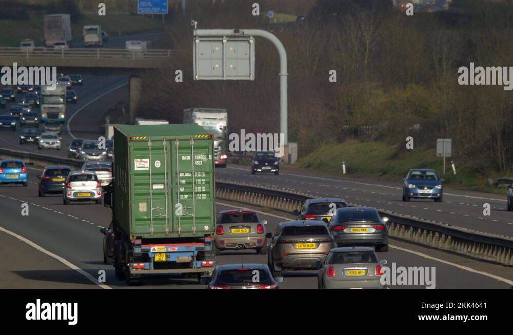 Busy motorway traffic with signs. Going round a curve. Extreme long ...