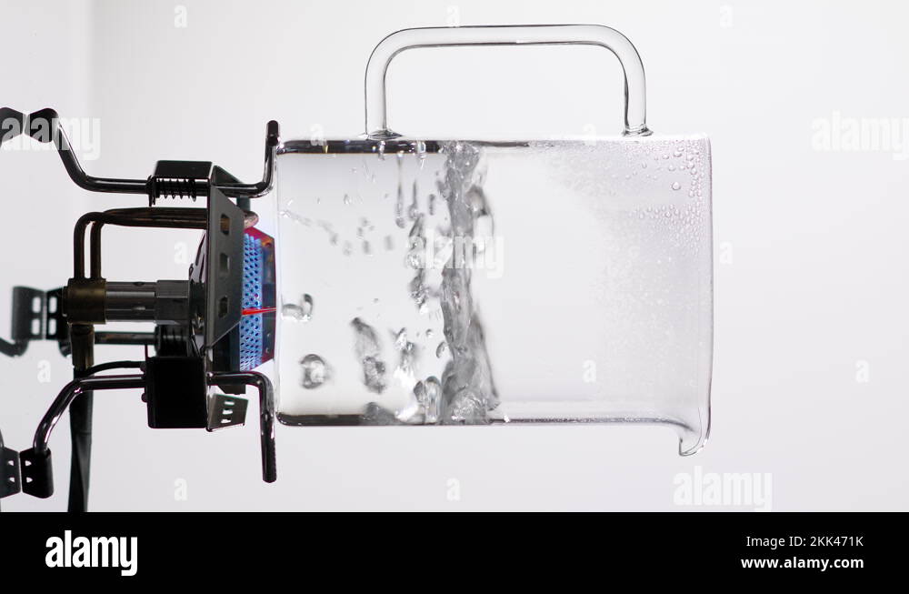 Boiling Water vertical video. Liquid Boils in a Transparent container ...