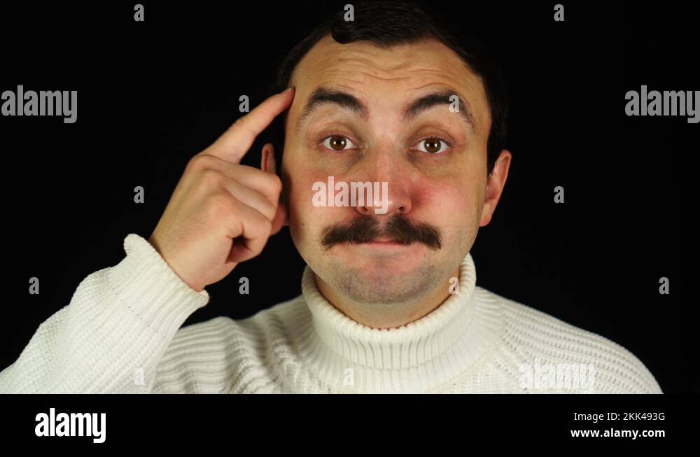 Man with mustache makes a gesture with his hand to think with his head ...