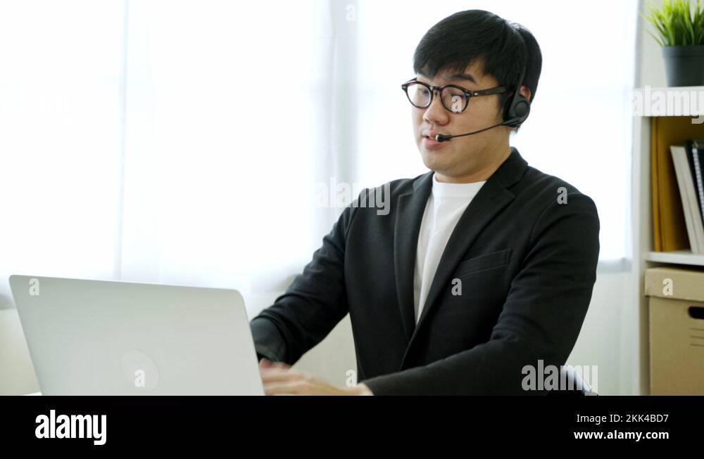 Work from home concept. Asian male business wear a black suit and ...