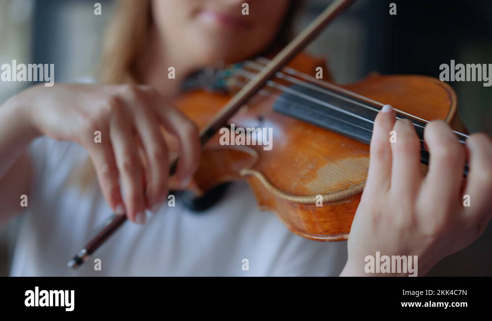 Woman hands playing violin. Musician pressing strings on violin with ...