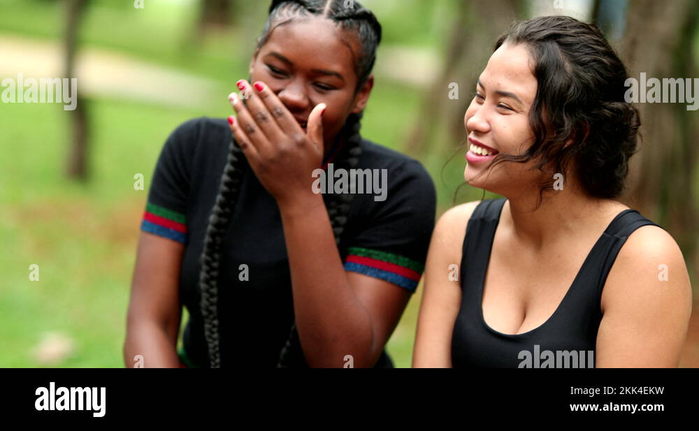 Candid female friends talking outside, real life laugh and smile Stock ...