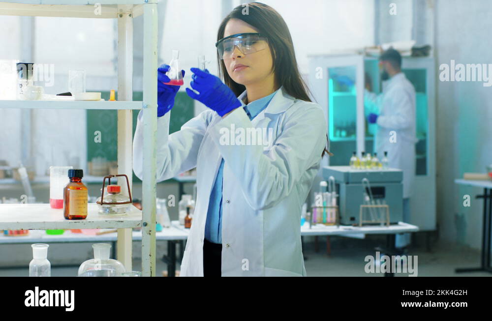 Beautiful scientist lady and her assistant using a lab tub with a ...