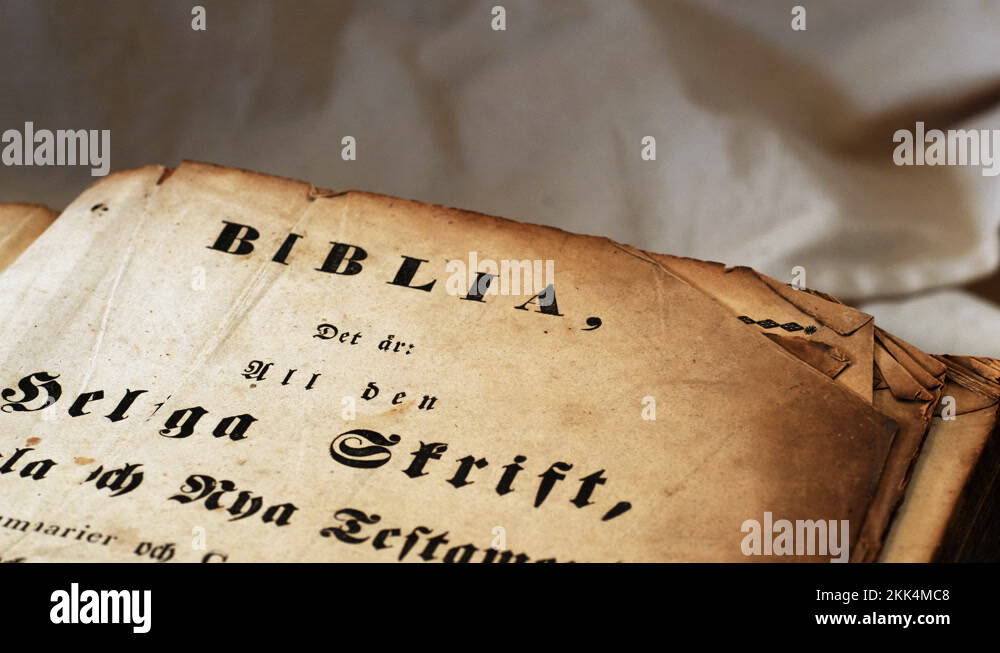 Close slide shot of old open bible book with worn texture, ancient ...