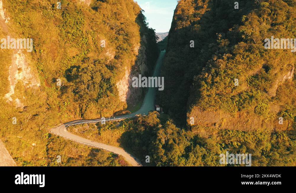 Amazing road inside a tropical rainforest mountain crack at sunrise ...