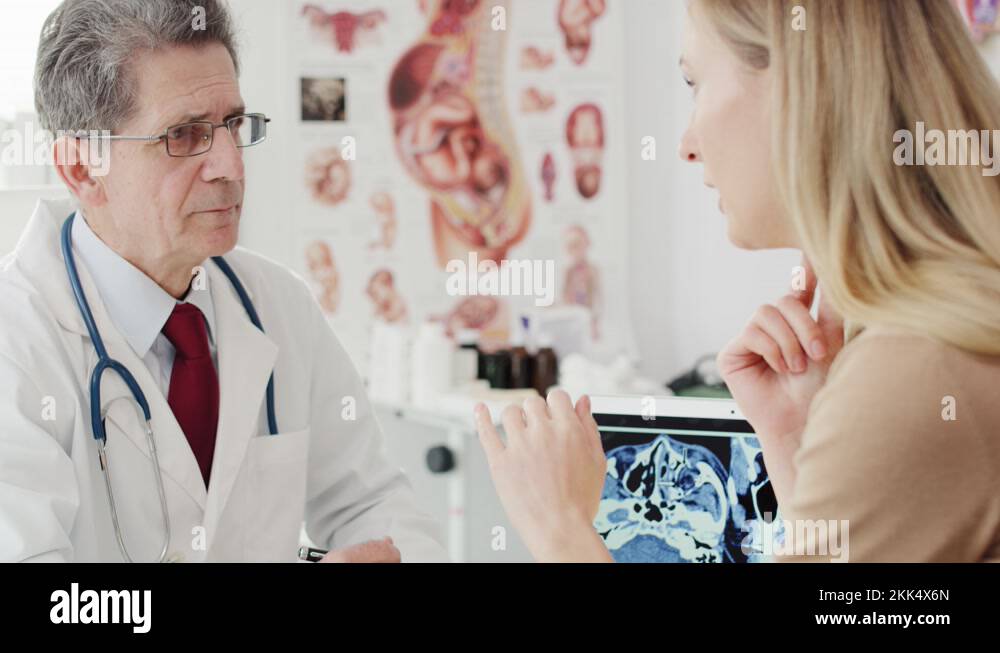 Handheld view of woman talking with gynecologist in doctor’s office ...