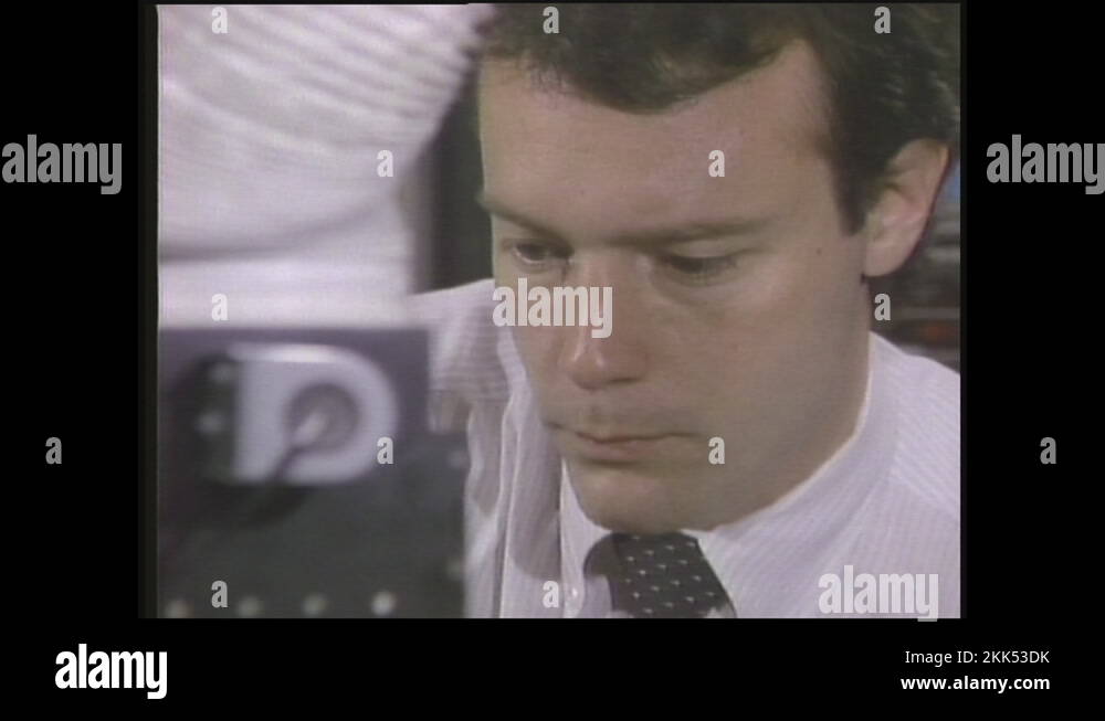 1990s: Green laser light appears on document. Man operates scanning ...