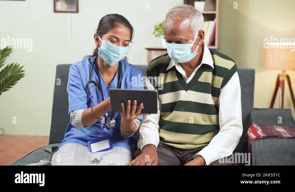 Doctor is explaining to senior how to care health by using Tab Stock ...