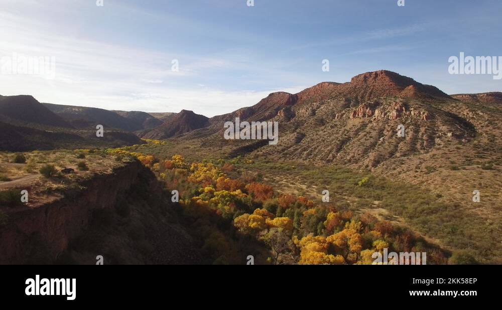 A slow aerial descent into the ribbon of colorful fall foliage at ...