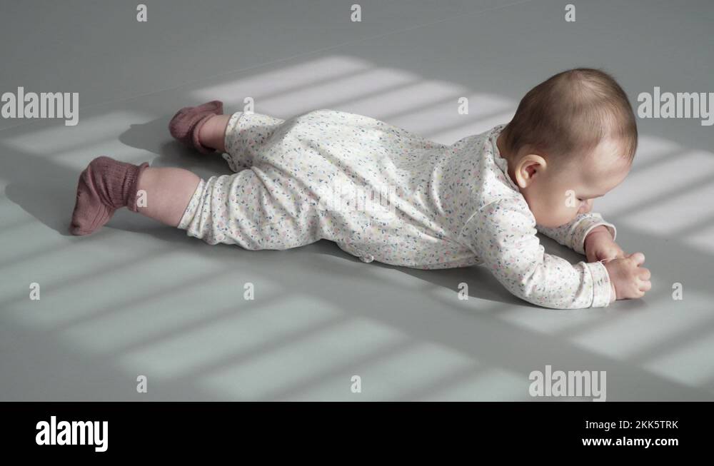 Baby Lying On Her Back With Sunlight Through Window On Sunny Morning ...
