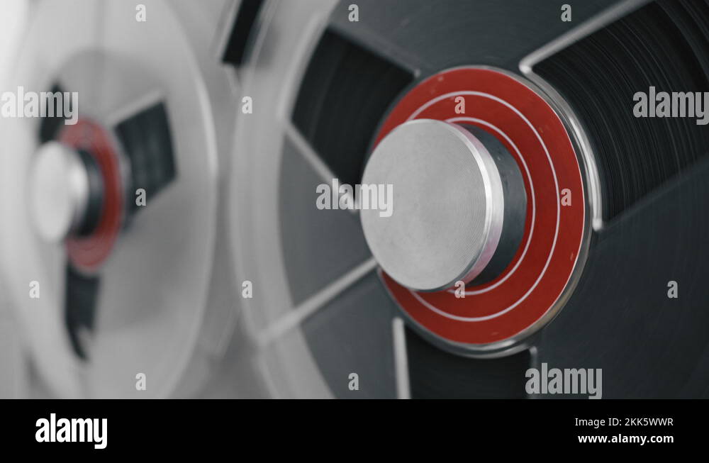 Reel to reel tape recorder playing. Rotating vintage music player ...