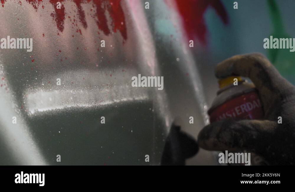 Slow motion of man's hand that draws on the wall, graffiti concept in ...