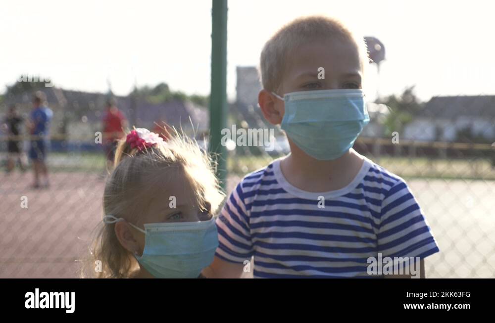 little children boy,girl are wearing medical safety mask.Children play ...