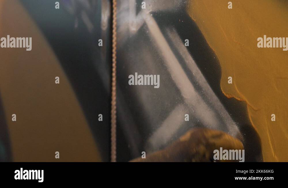 Slow motion of street art at night. Man is drawing with spray paint on ...