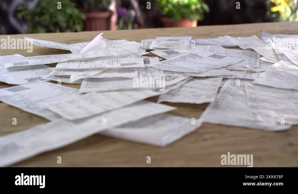 Pile of overdue unpaid utility bills, checks, shopping receipts ...