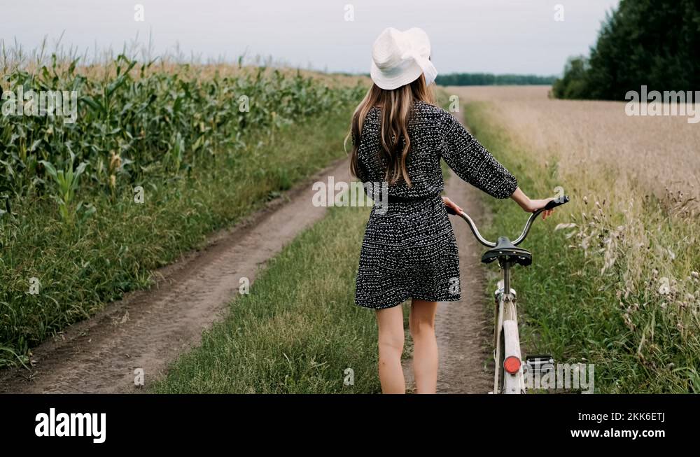 Beautiful Girl Rides An Old Bicycle Through Village Field. Happy girl ...