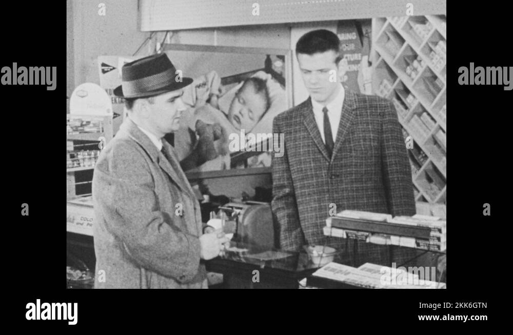 1960s: Men in store, shake hands. Men talking at counter. Man and woman ...