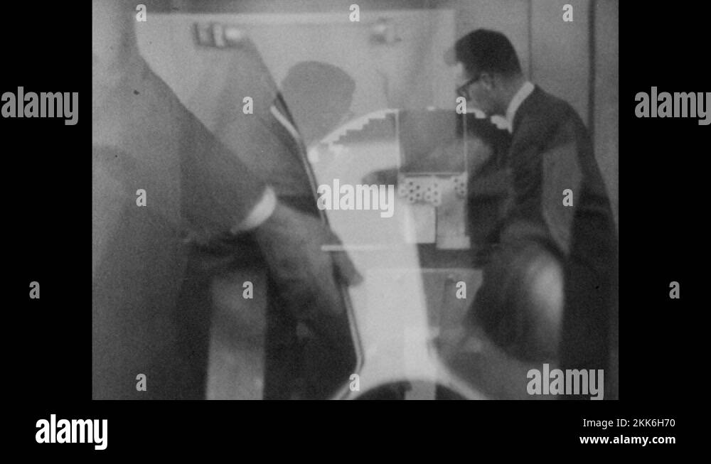 1960s: Men touch model of orbiting solar observatory. Man touches model ...