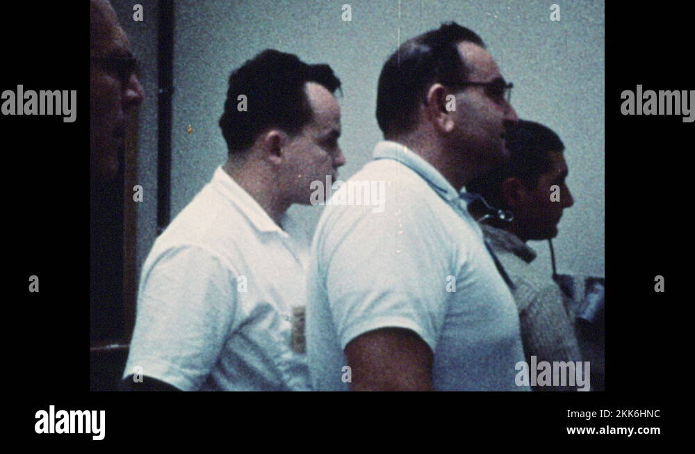1960s: Men stand and work in control room. Explosion in sky. Men talk ...