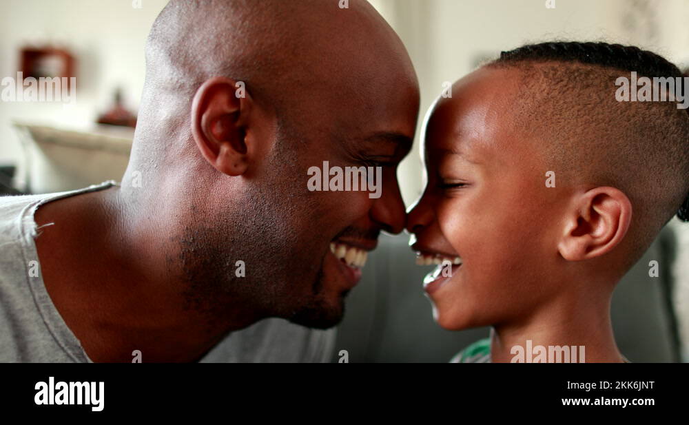 Father and boy bonding together. African dad making child laugh, face ...