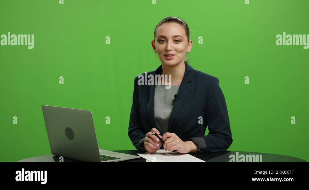Professional female news anchor talking during live broadcast ...