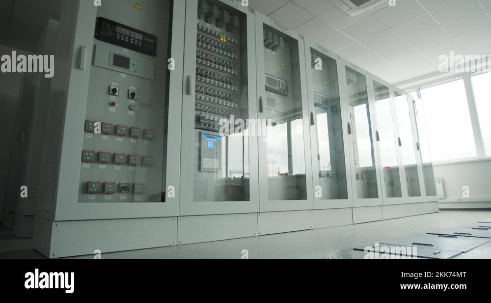 Big modern transformers with glass doors at the factory, control room ...