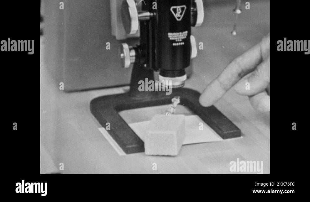 1960s: Person in lab points at tube under microscope. Burned out ...