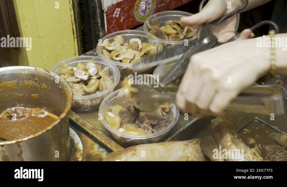 Cutting Freshly Cooked Beef Intestines And Adding To Plastic Containers ...