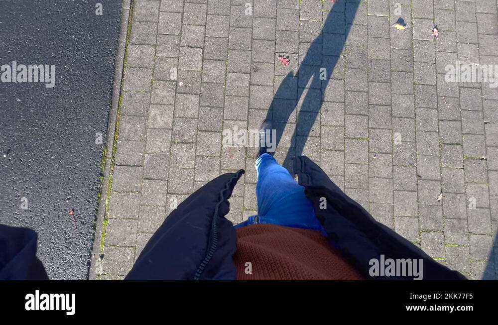 Pov top down shot of person walking alone along a stony path in nature ...