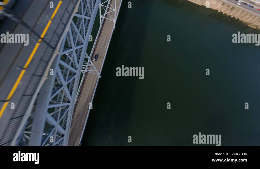 Fly over train and cars towards water FPV drone Dom Luis bridge Porto ...